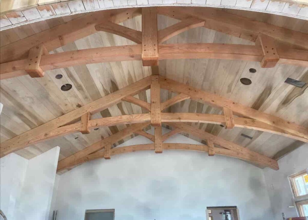 Timber frame trusses create an open and dramatic effect